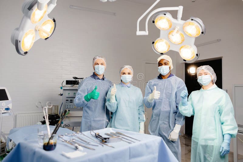 Group of Doctors Discussing Patient Cases Around Table Stock Photo ...