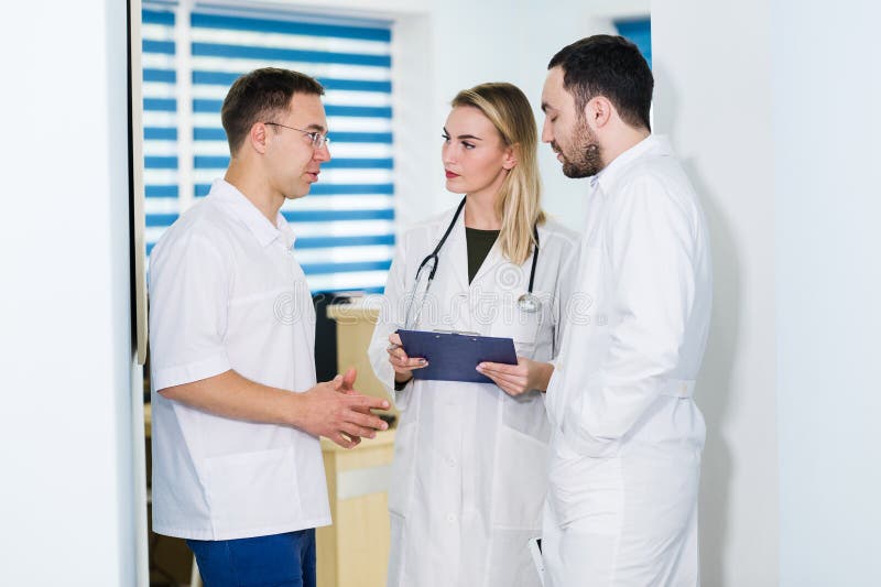 Group of Doctors Discussing and Working Together Stock Image - Image of ...