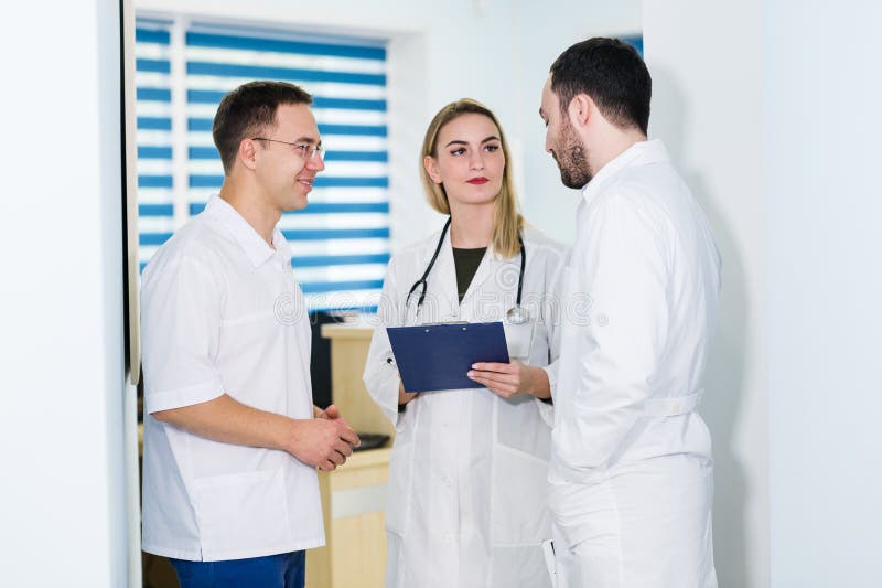 Group of Doctors Discussing and Working Together Stock Photo - Image of ...