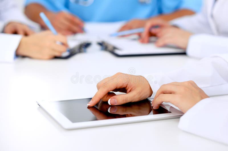 Group of Doctors at Medical Meeting. Close Up of Physician Using Tablet ...