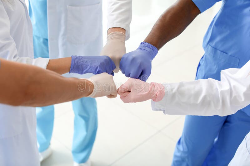 Group of Doctors Putting Hands Together in Clinic. Unity Concept Stock ...