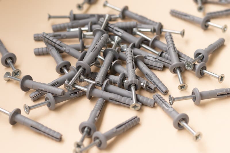A Group of Dowels and Nails on a Yellow Background Stock Image - Image ...