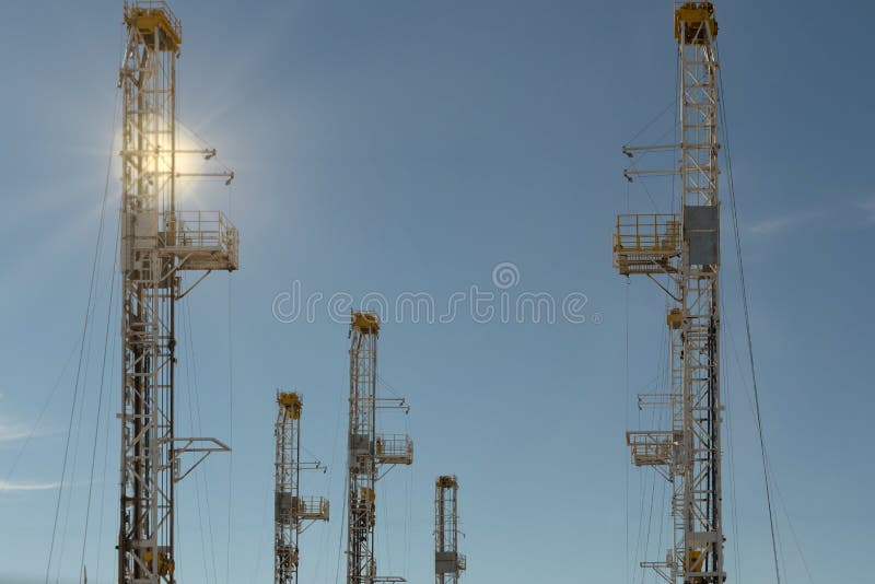 Group of Drilling Rigs at Sunset Stock Image - Image of machinery ...