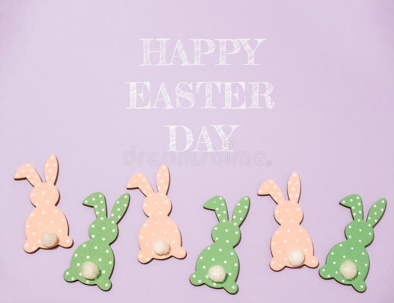 Group of Easter Bunny Figurines are Arranged in a Row on a Purple ...