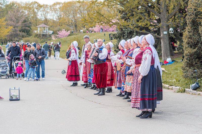A Group of Eastern European Folk Singers Performing Outdoors, Dressed ...