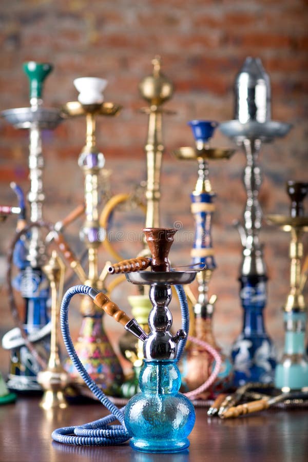 Group of Eastern Hookahs on Wood Table Stock Photo - Image of ...