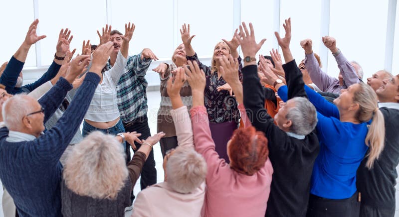 A Group of Elderly People are Reaching Up Stock Photo - Image of team ...