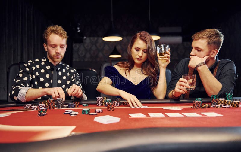 Group of Elegant Young People that Playing Poker in Casino Together ...