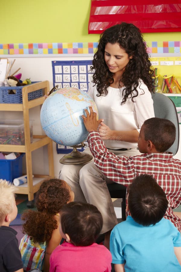 Group of Elementary Age Schoolchildren in Class with Teacher Stock ...