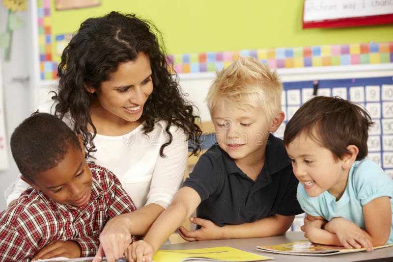 Group of Elementary Age Schoolchildren in Class with Teacher Stock ...