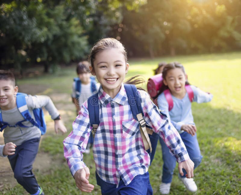 Group of Elementary School Kids Running on the Grass Stock Photo ...