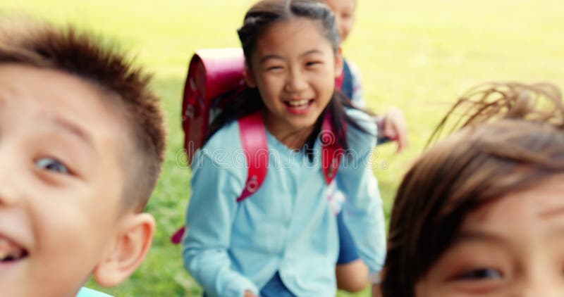 Group of Elementary School Students Sit on a Bench in the Schoolyard ...