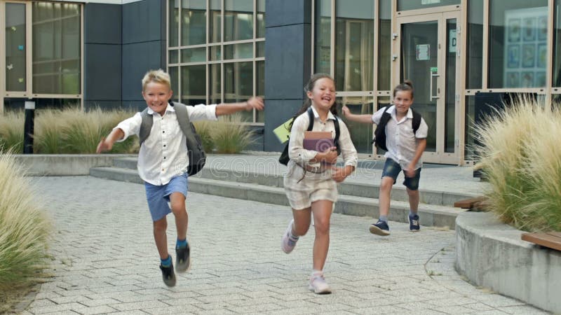 Group of Elementary School Students Joyfully Run Out of the School ...