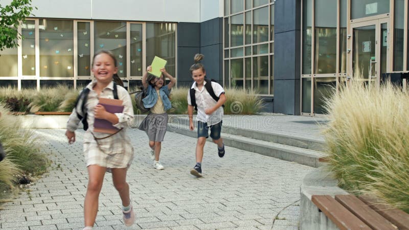 Group of Elementary School Students Joyfully Run Out of the School ...
