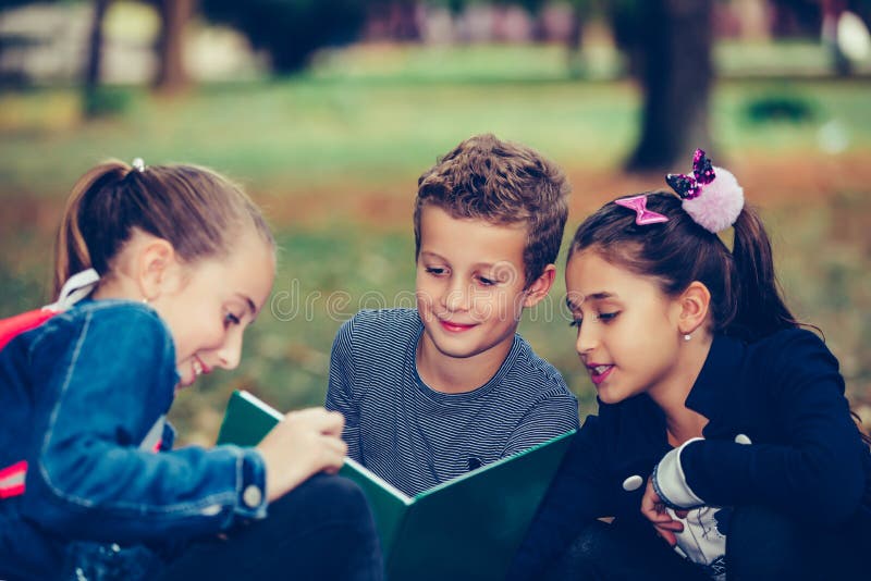 Group of Elementary Schoolkids Having Discussion of Homework while ...