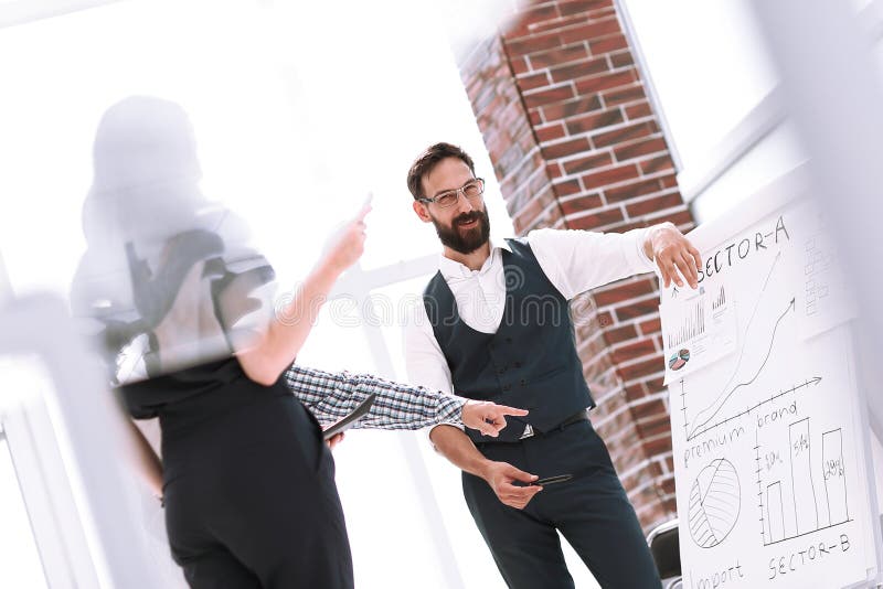 Group of Employees Discussing Financial Performance while Standing in ...