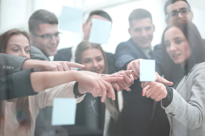 Group of Employees Pointing at a Sticky Note. Stock Image - Image of ...