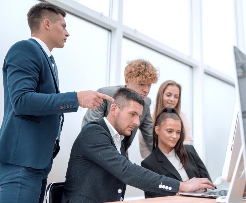 Group of Employees Reading Information on a Computer Screen Stock Photo ...