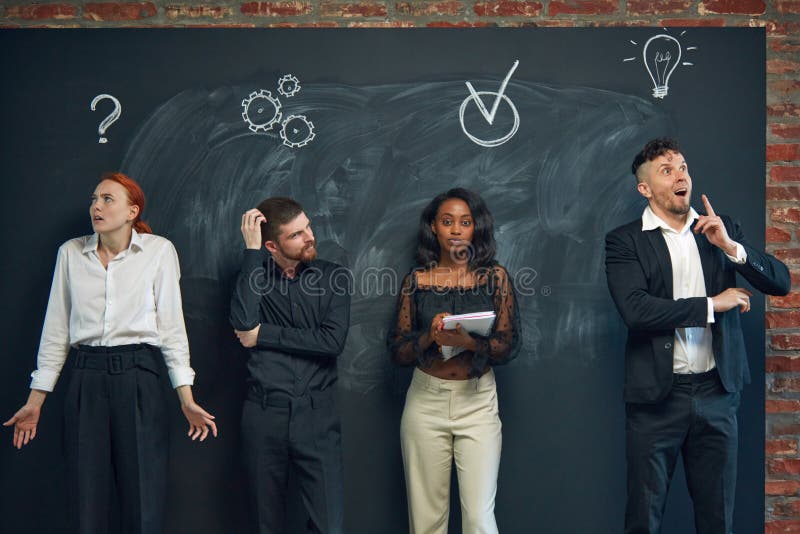 Group of Employees Standing by Blackboard with Drawn Business Icons ...