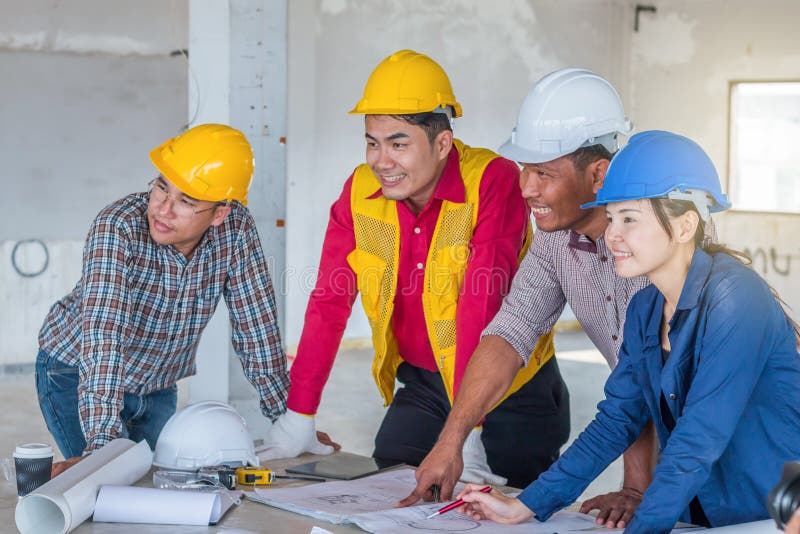 Group of Engineer Checking the Blueprint with Laptap and Talking about ...