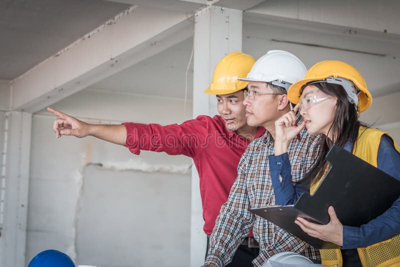 Group of Engineer Checking the Blueprint on the Table and Talking about ...