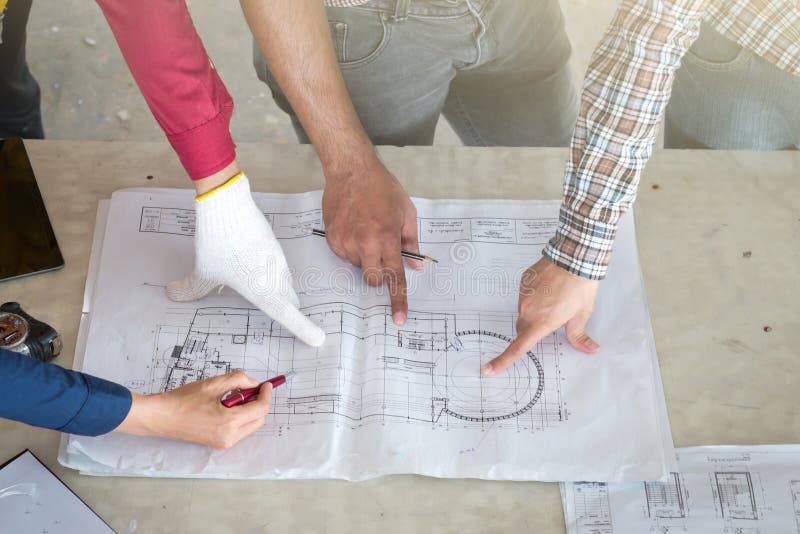 Group of Engineer Checking the Blueprint on the Table and Talking about ...