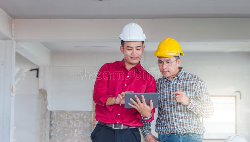 Group of Engineer Checking the Blueprint on the Table and Talking about ...
