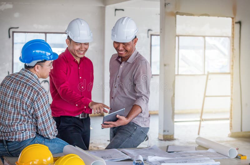 Group of Engineer Checking the Blueprint on the Table and Talking about ...