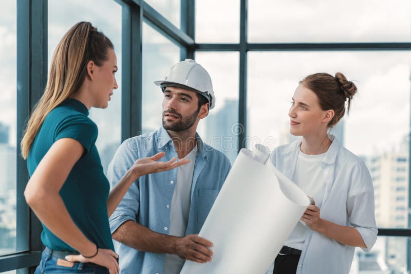 Group of Engineer Looking at Project Plan while Brainstorming Idea ...