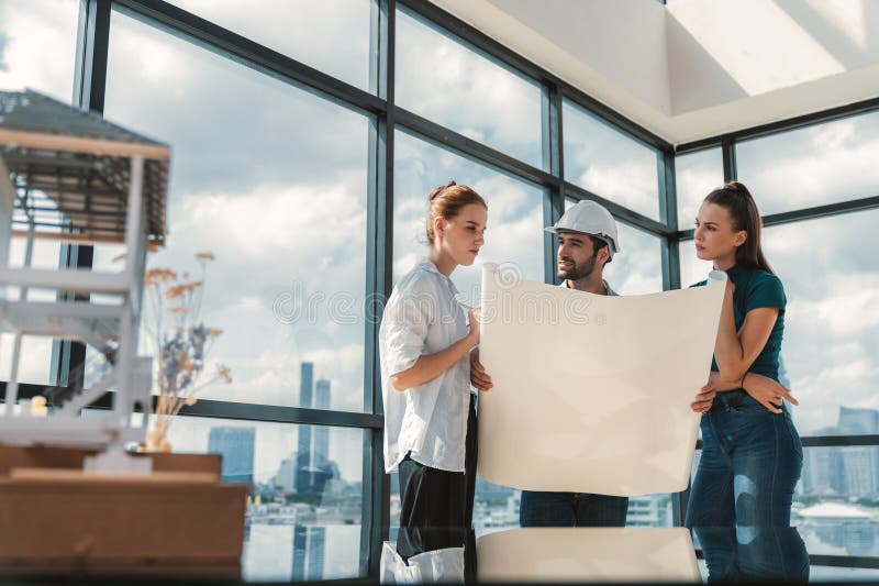 Group of Engineer Looking at Project Plan while Brainstorming Idea ...