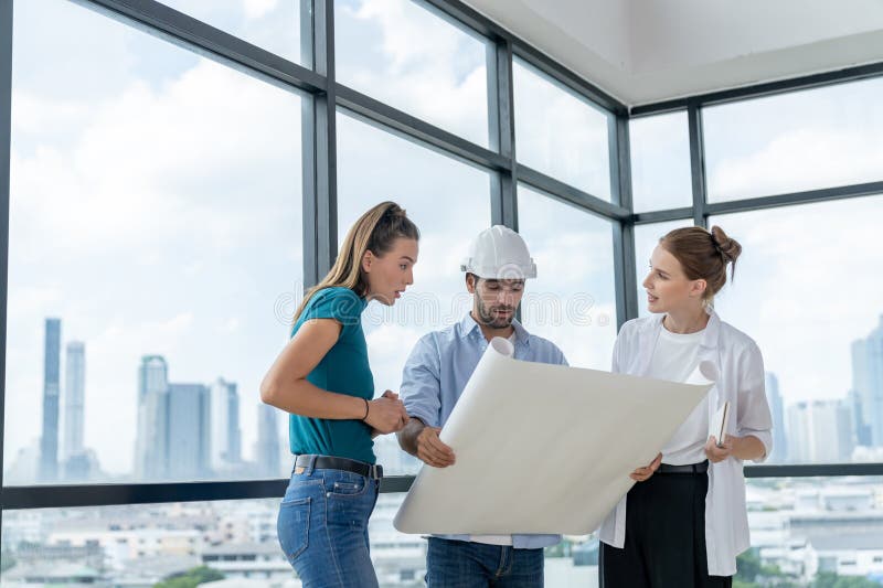 Group of Engineer Looking at Project Plan while Brainstorming Idea ...
