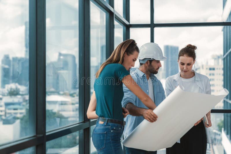 Group of Engineer Looking at Project Plan while Brainstorming Idea ...