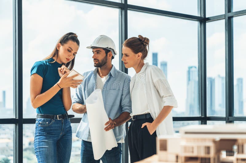Group of Engineer Looking at Project Plan while Brainstorming Idea ...