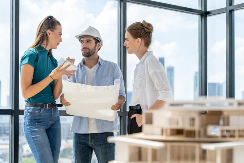 Group of Engineer Looking at Project Plan while Brainstorming Idea ...