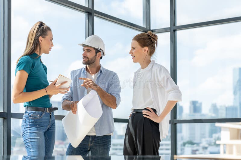 Group of Engineer Looking at Project Plan while Brainstorming Idea ...