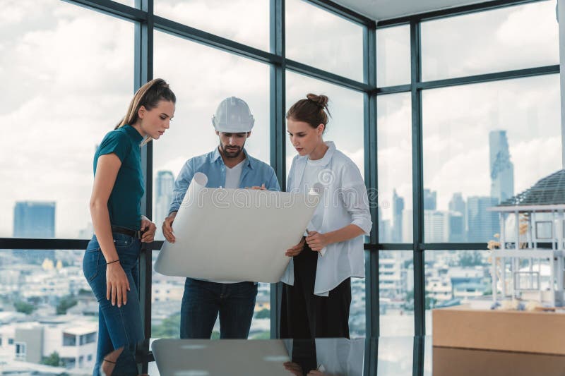 Group of Engineer Looking at Project Plan while Brainstorming Idea ...