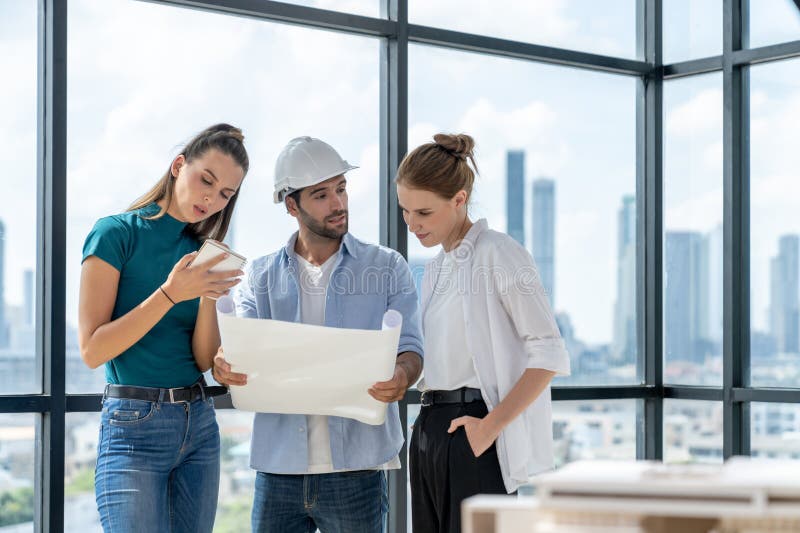 Group of Engineer Looking at Project Plan while Brainstorming Idea ...