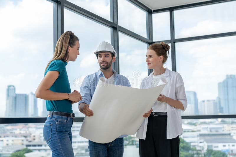 Group of Engineer Looking at Project Plan while Brainstorming Idea ...
