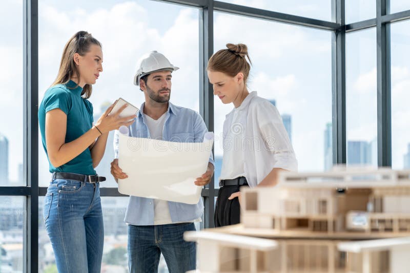 Group of Engineer Looking at Project Plan while Brainstorming Idea ...