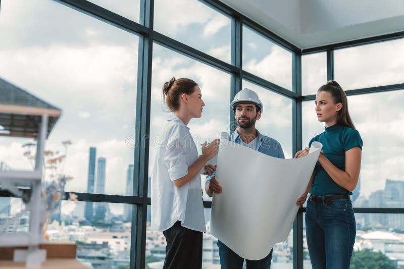 Group of Engineer Looking at Project Plan while Brainstorming Idea ...