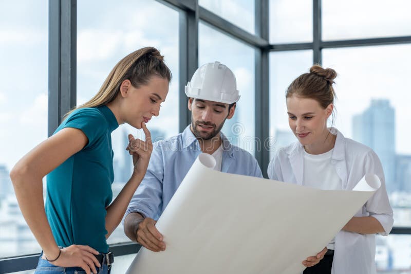 Group of Engineer Looking at Project Plan while Brainstorming Idea ...