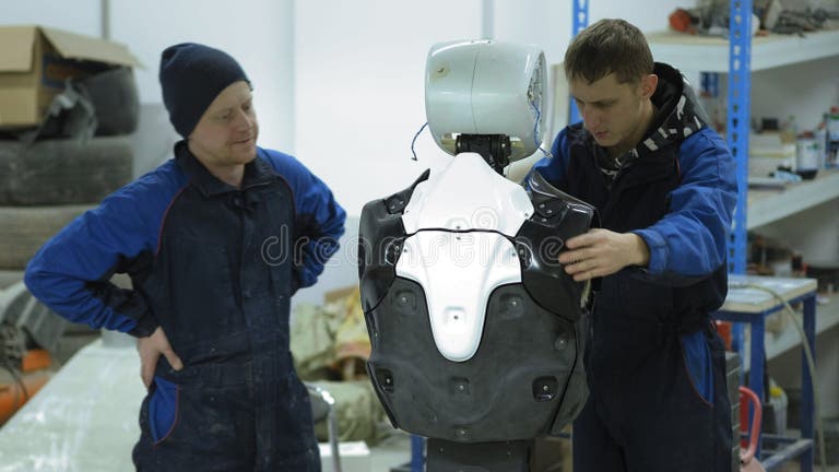 A Group of Engineers Creates a Modern Robot or Android. Check and ...