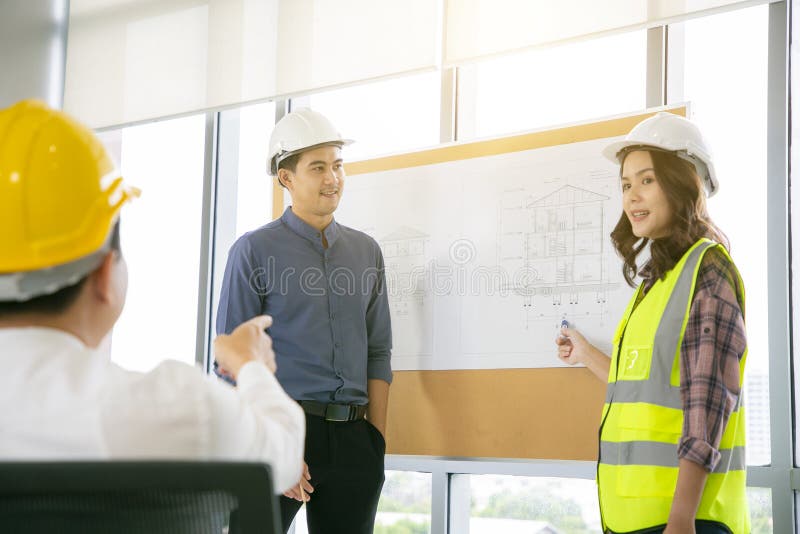 Group of Engineers Discussion and Presenting Blueprint on Board at ...