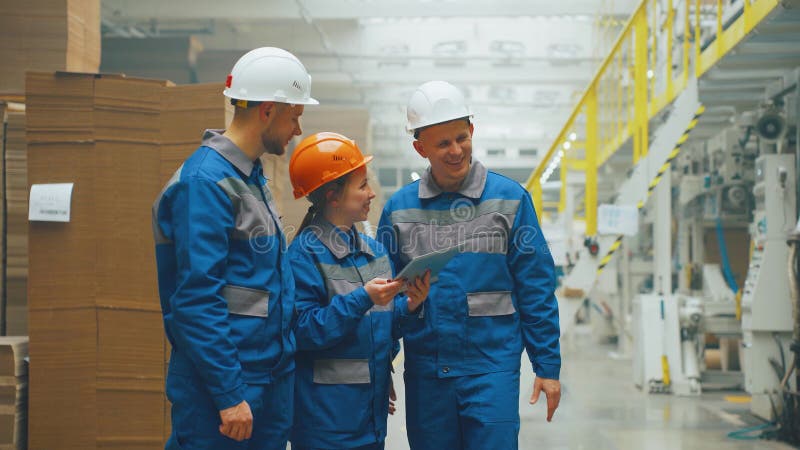 Workers in a Modern Factory Discuss Operation of a CNC Machine ...