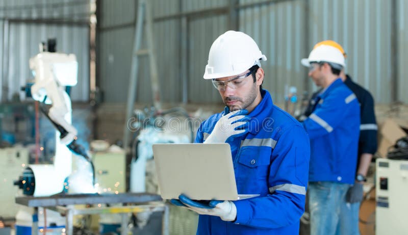 Group of Engineers are Manipulating a Welding Robot Hand. by Combining ...