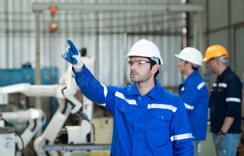 Group of Engineers are Manipulating a Welding Robot Hand. by Combining ...