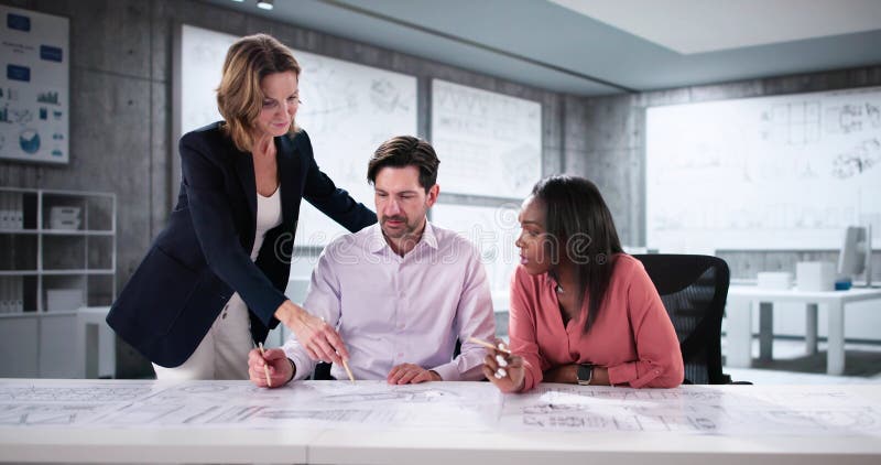 Group of Engineers Reviewing Blueprints Stock Image - Image of designer ...