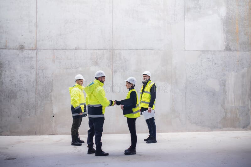 Group of Engineers Standing on Construction Site, Shaking Hands. Stock ...