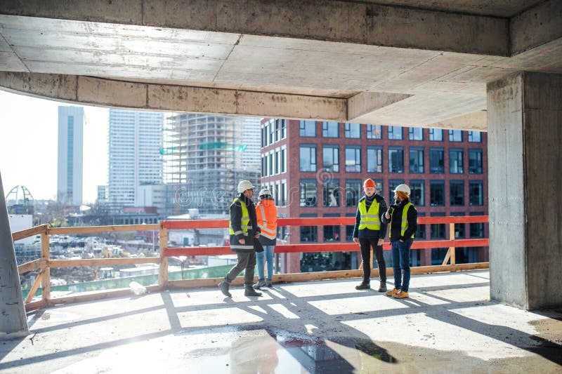 Group of Engineers Standing on Construction Site, Talking. Stock Image ...