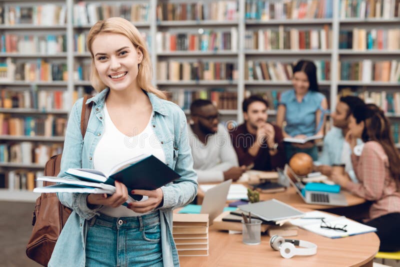 Group of Ethnic Multicultural Students in Library. White Girl Reading ...